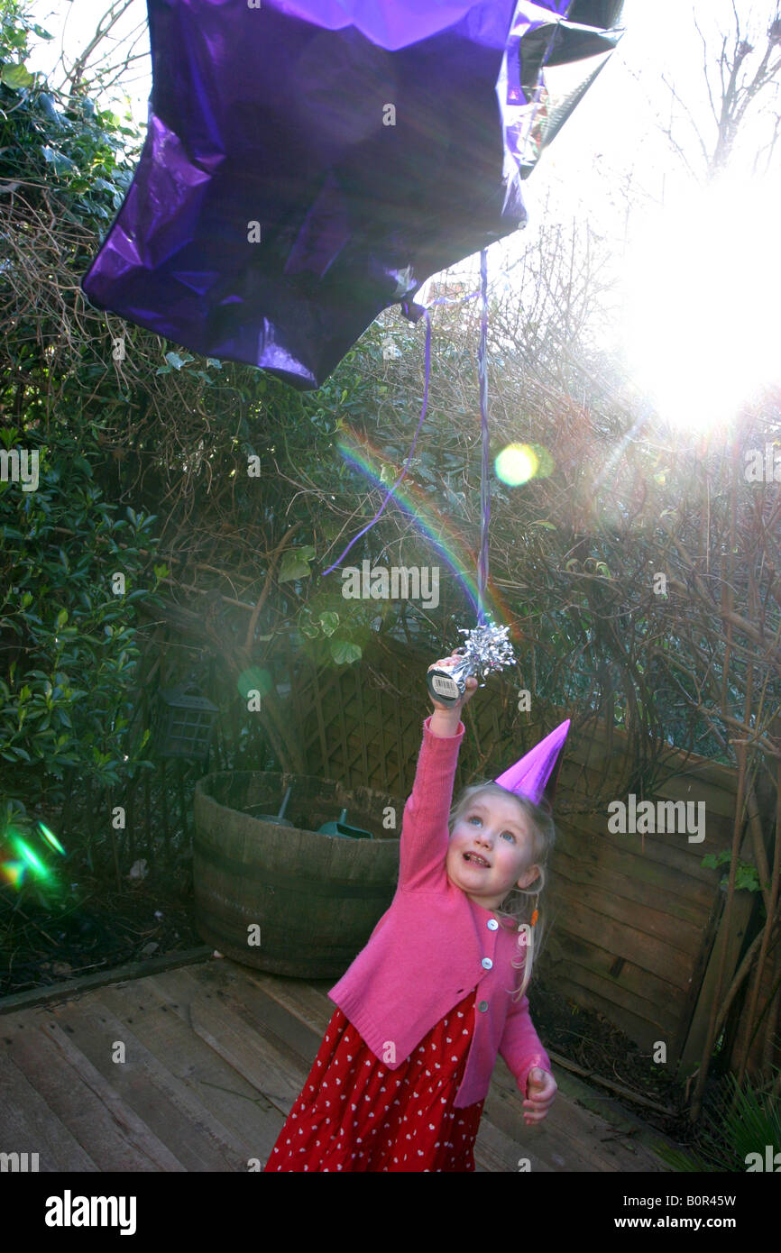 Girl holding helium balloon Stock Photo - Alamy