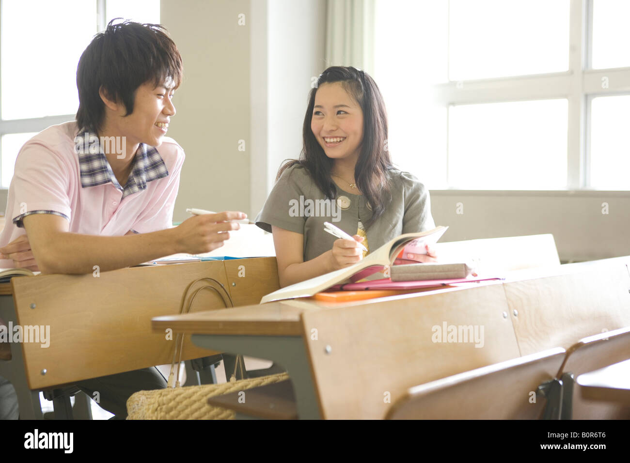 Two students reading in lecture hall Stock Photo - Alamy