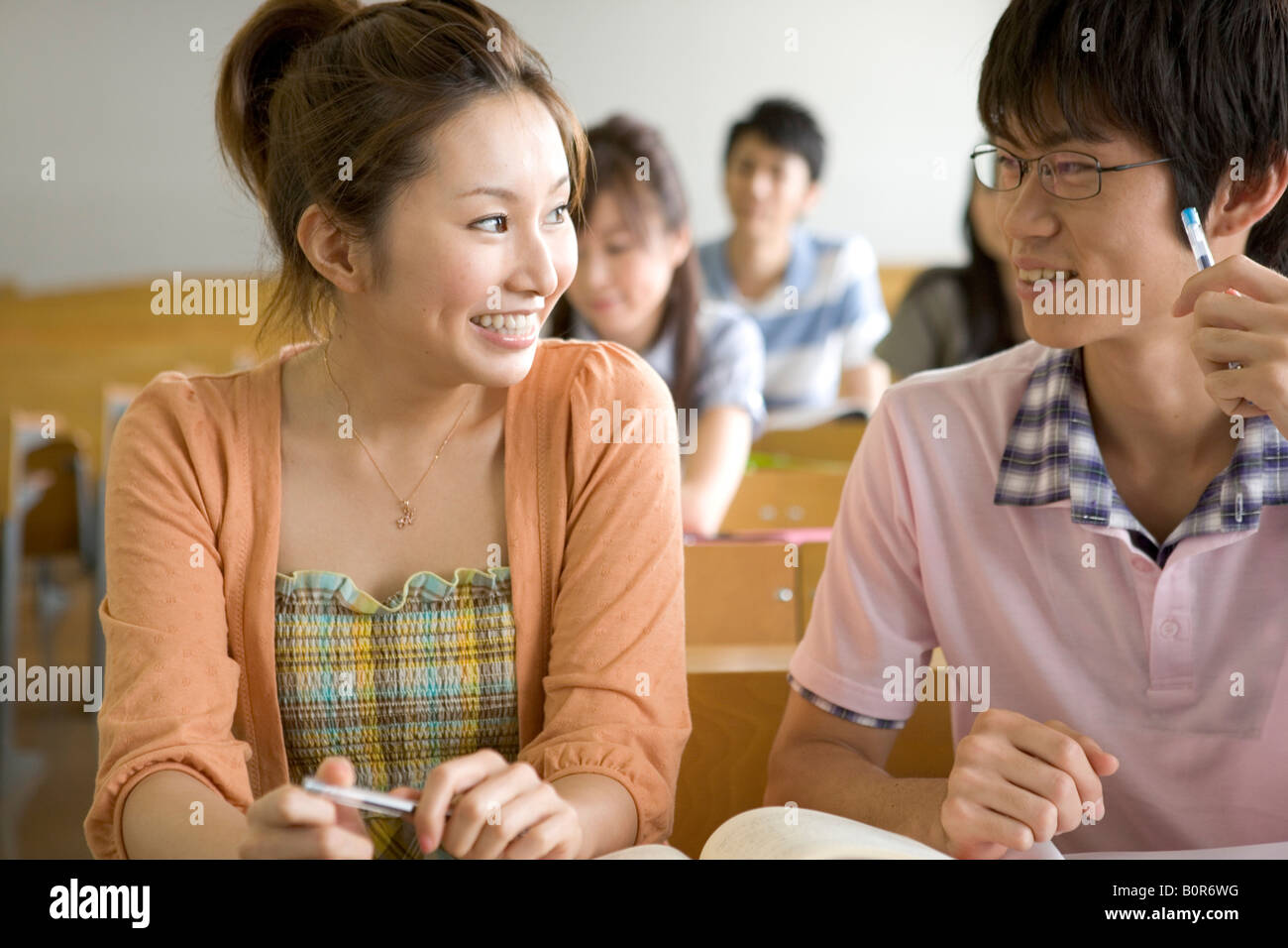 Two students talking at desk hi-res stock photography and images - Alamy