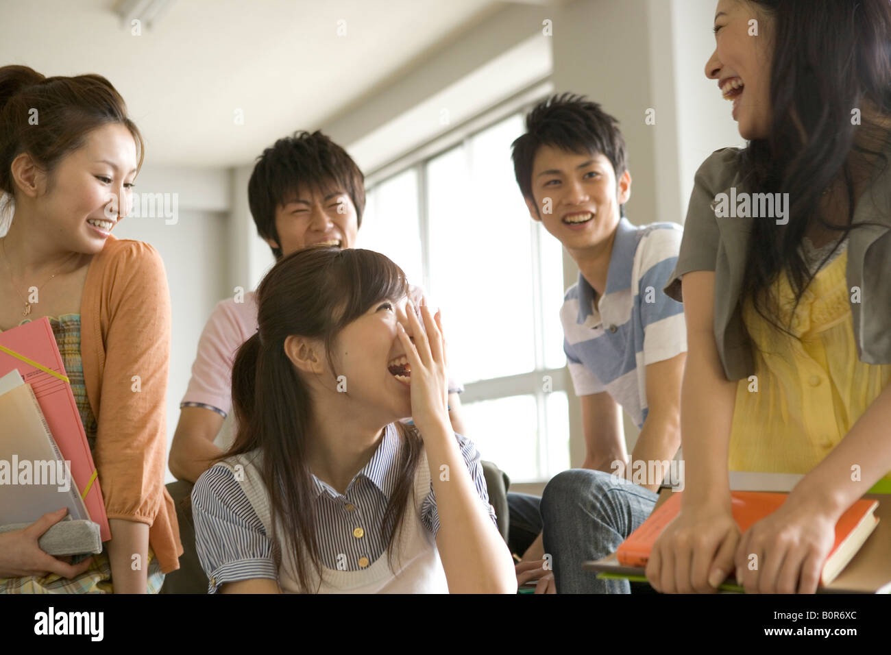 Students laughing in classroom Stock Photo - Alamy