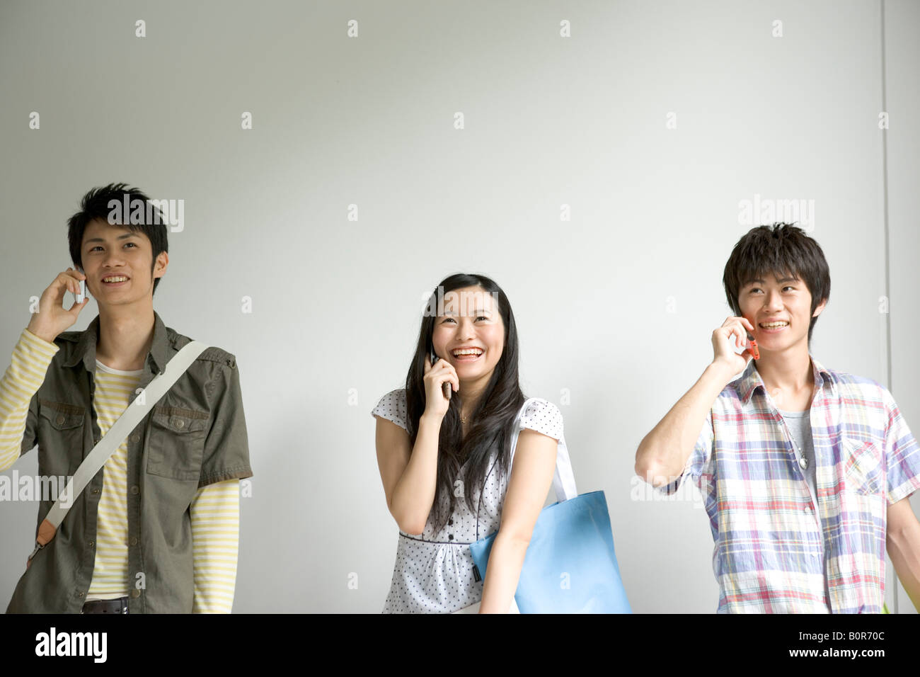 Five students talking on mobile phones Stock Photo - Alamy