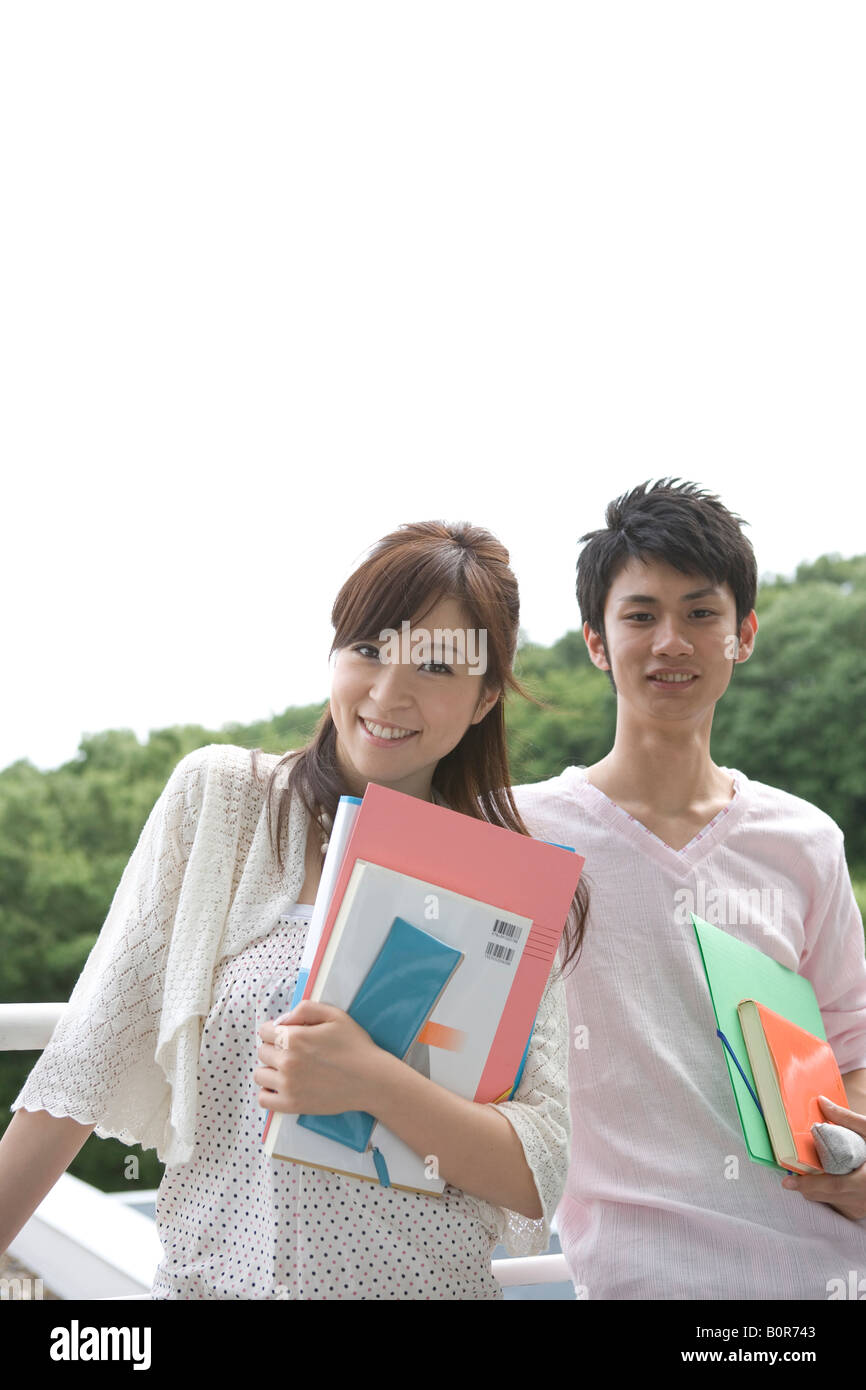Students leaning on railing Stock Photo - Alamy