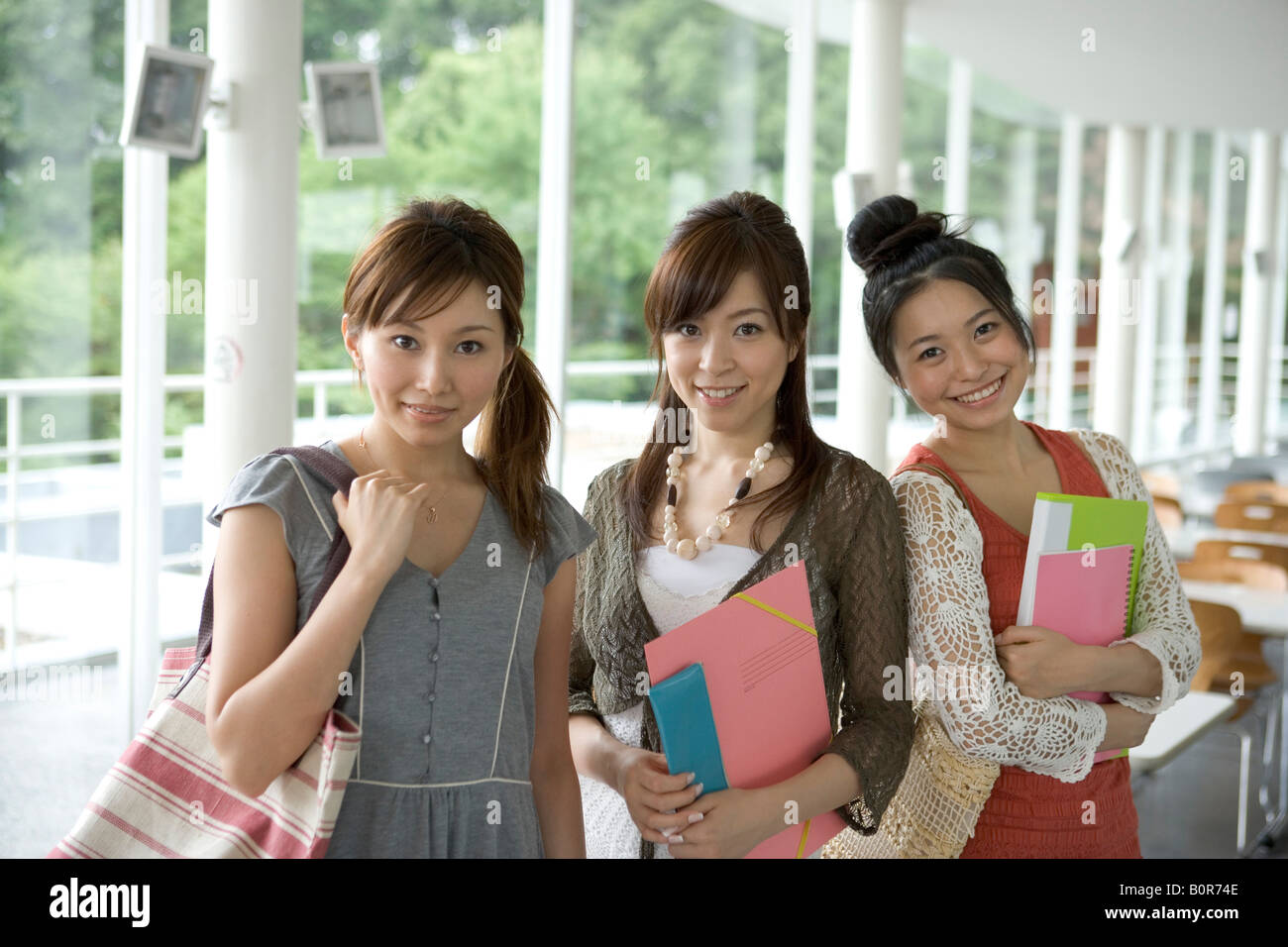 Portrait of three female students in classroom Stock Photo - Alamy