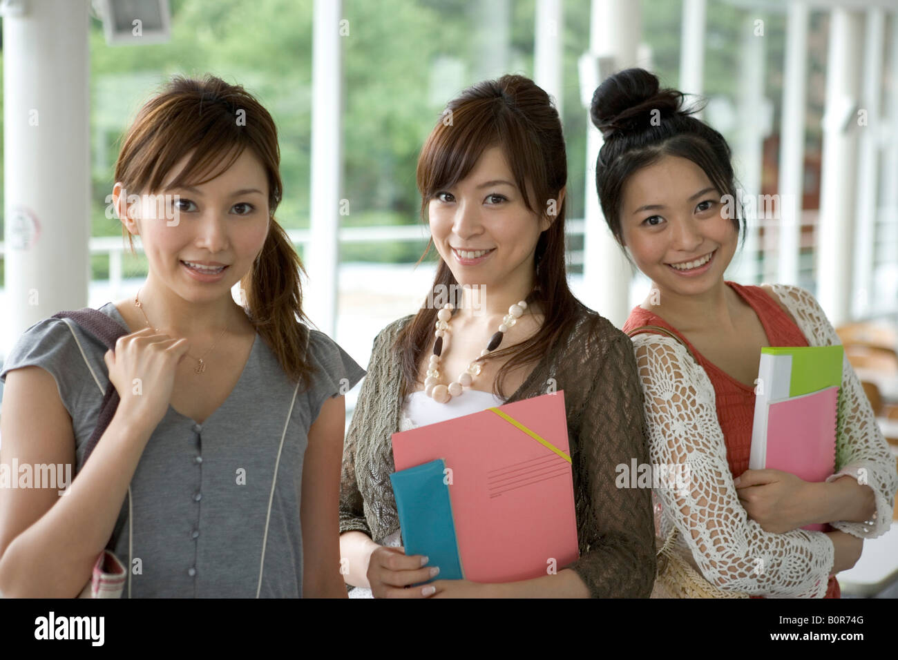 Portrait of three female students in classroom Stock Photo - Alamy