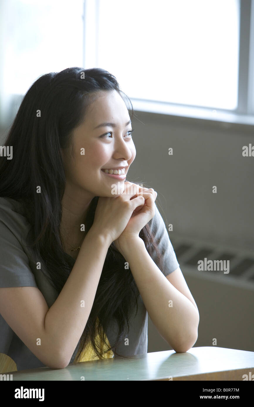 Female student sitting behind desk Stock Photo - Alamy