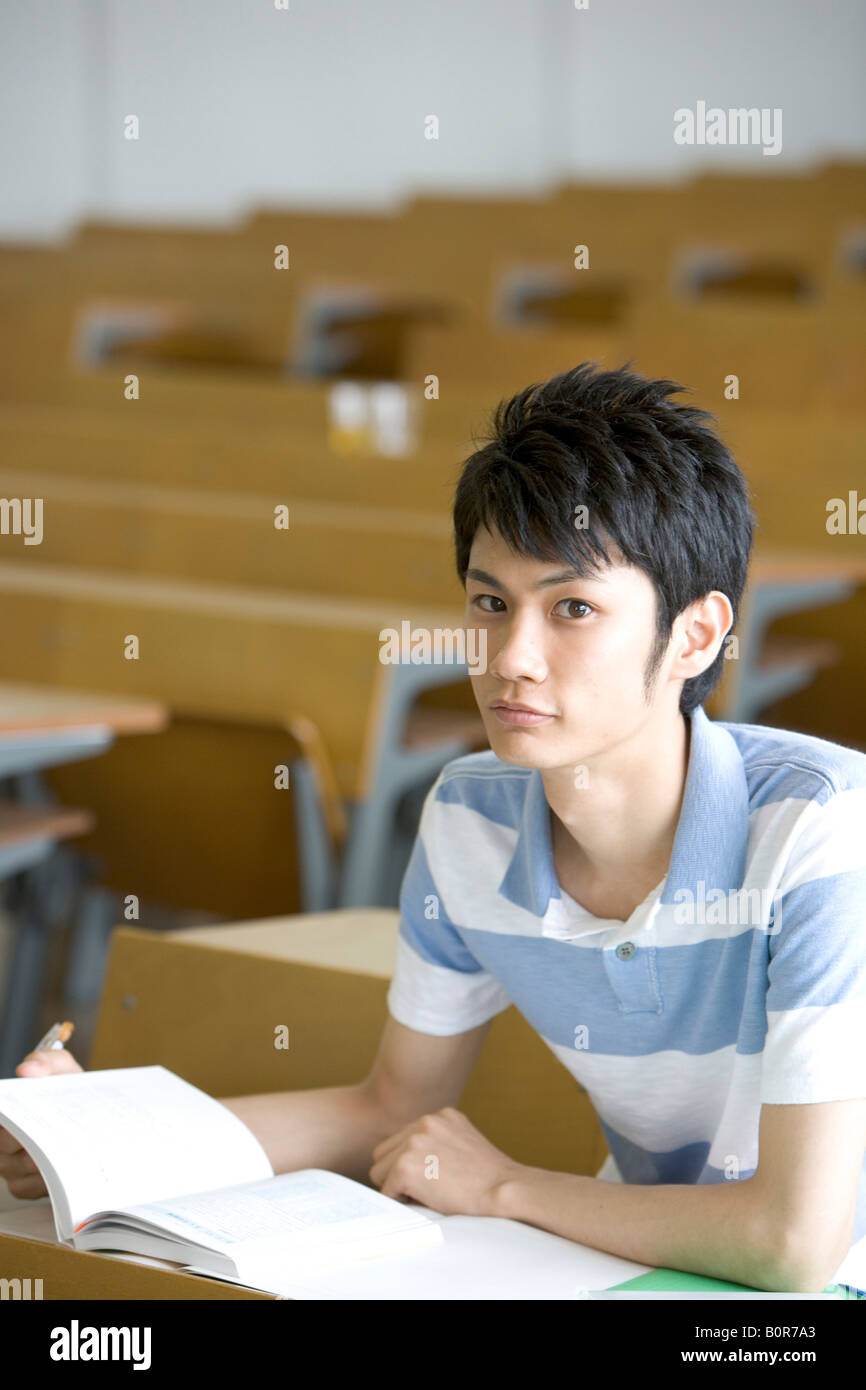Young male student in classroom Stock Photo - Alamy