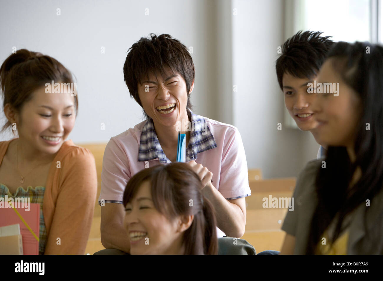 Students laughing in classroom Stock Photo - Alamy