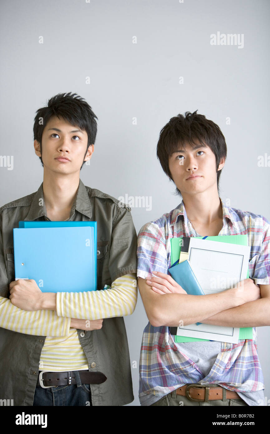 Two male students looking up Stock Photo - Alamy