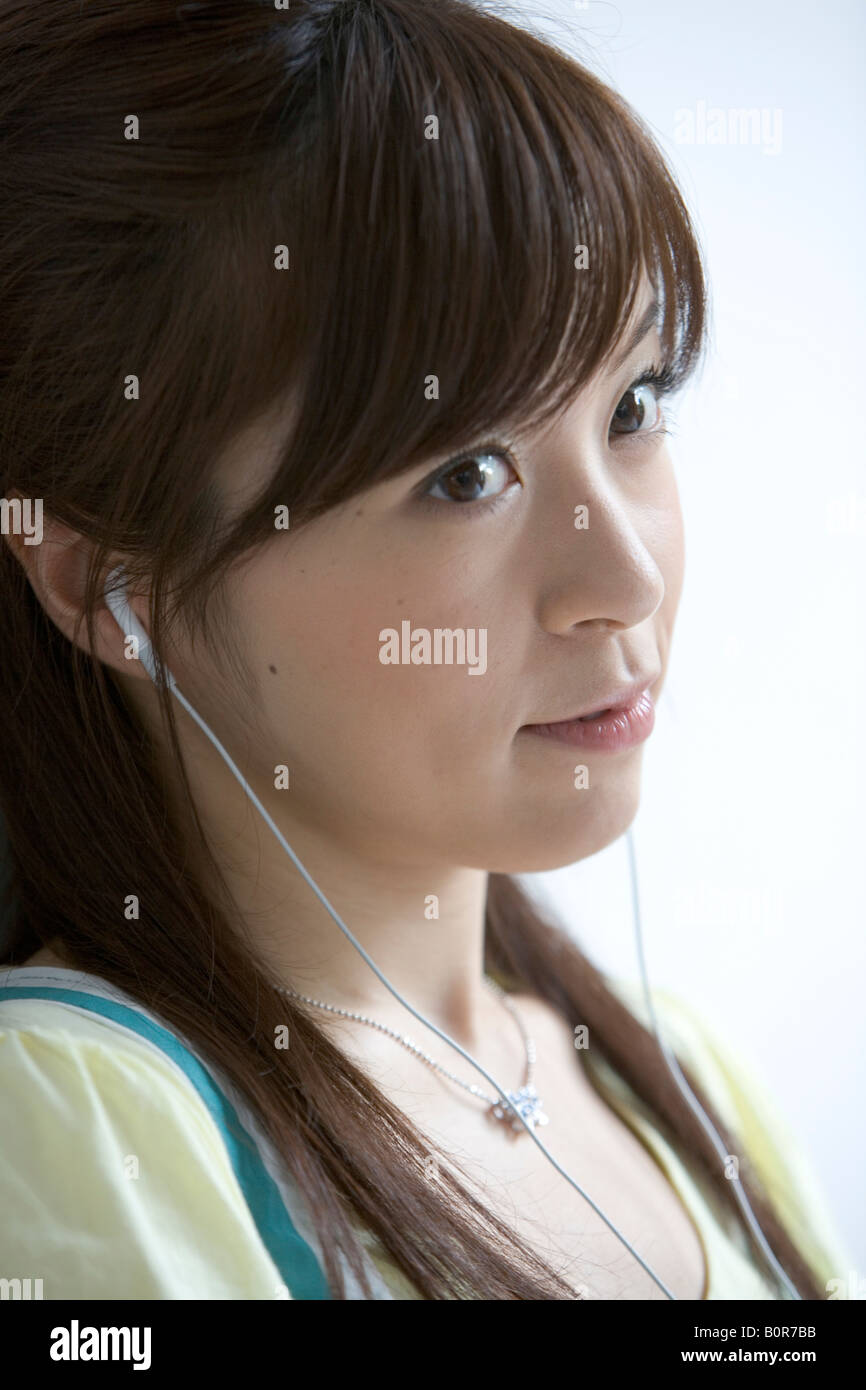 Young woman wearing earphones Stock Photo - Alamy