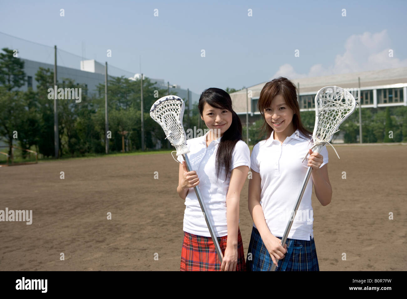 Portrait of teenage girls holding lacrosse stick Stock Photo - Alamy