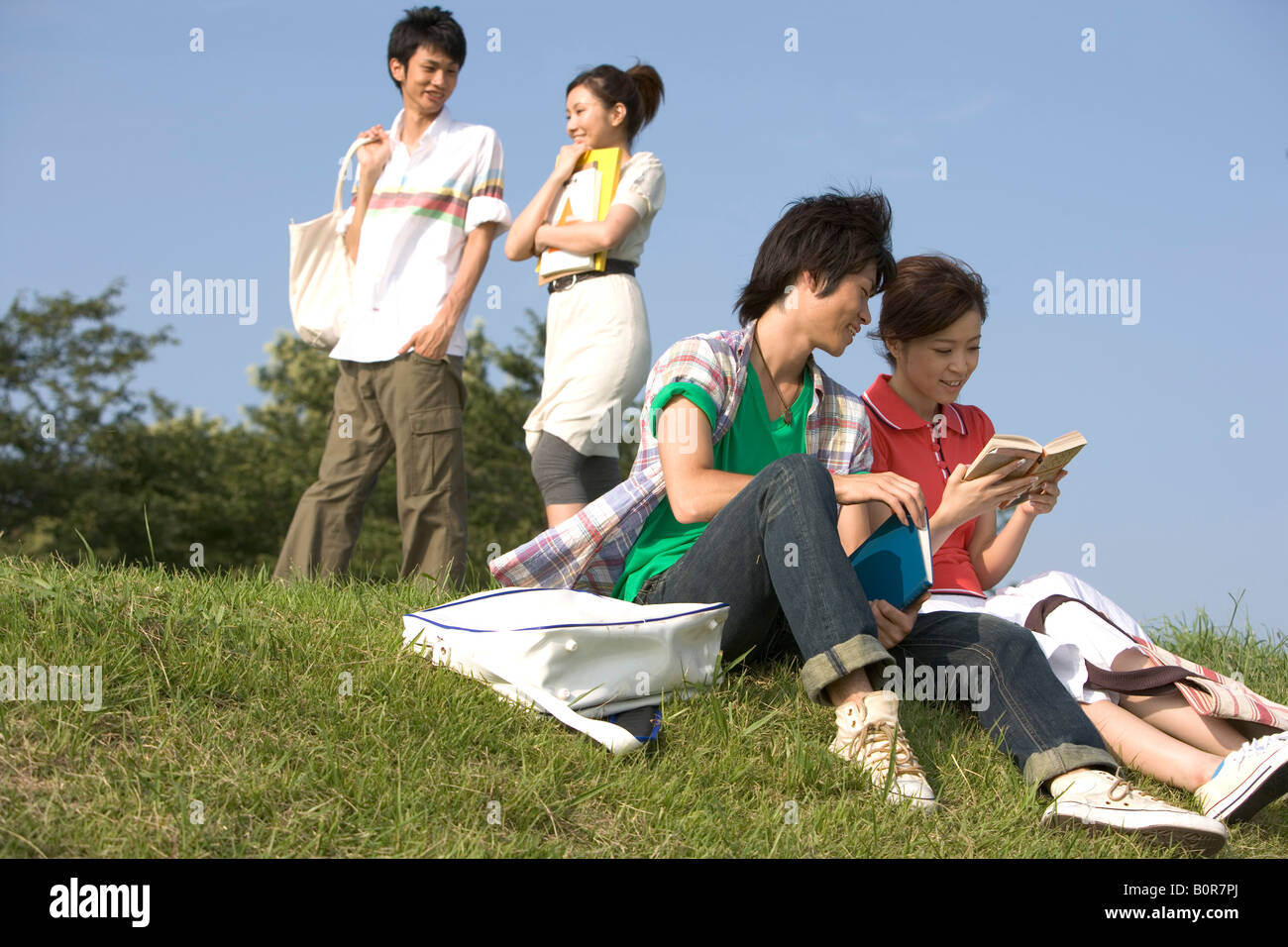 Young people relaxing in park Stock Photo - Alamy