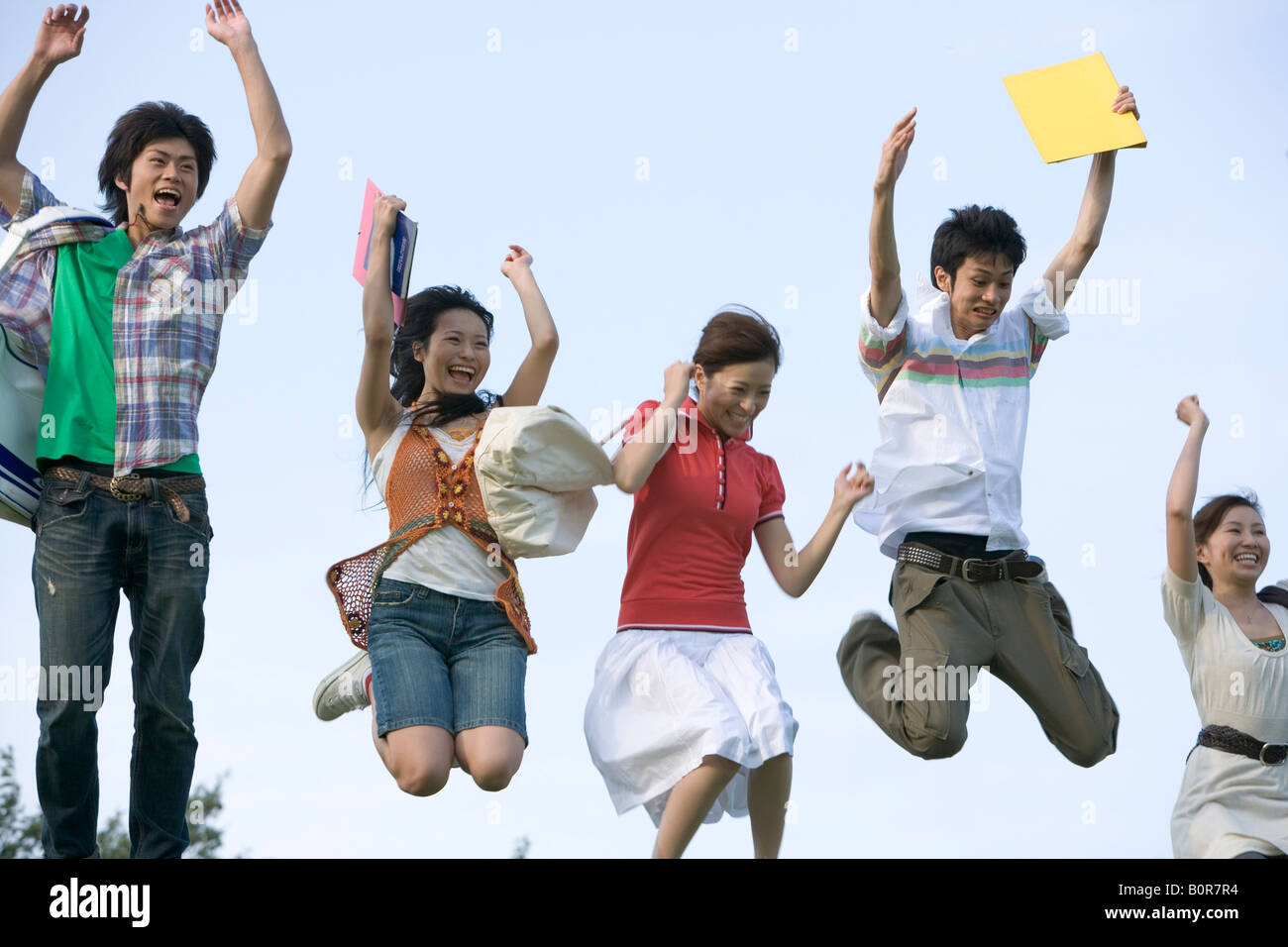 Young people jumping Stock Photo - Alamy