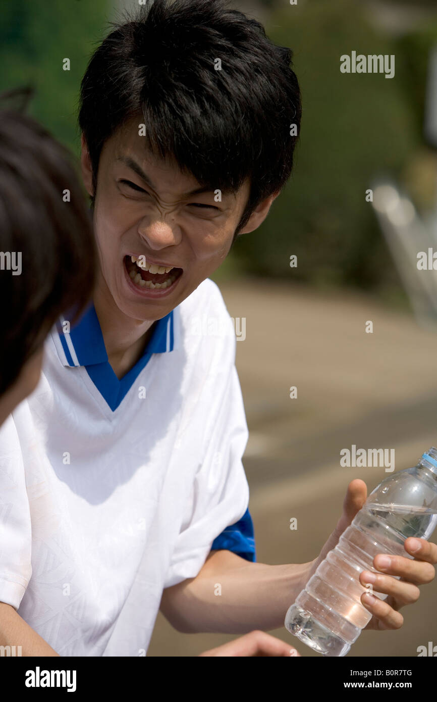 Teenage boy shouting to another outdoors Stock Photo - Alamy