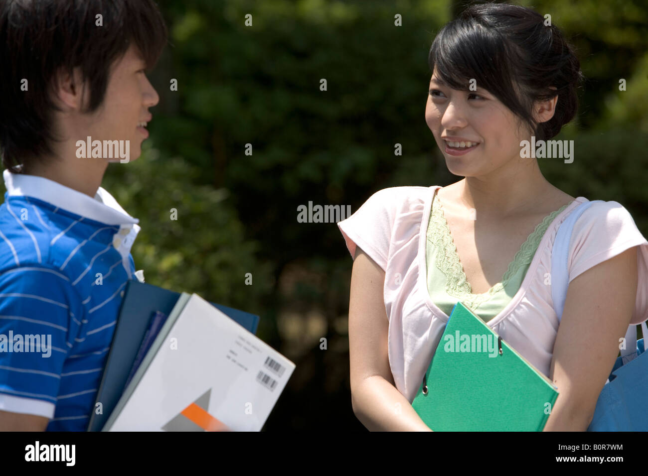 Teenage boy and girl talking Stock Photo - Alamy