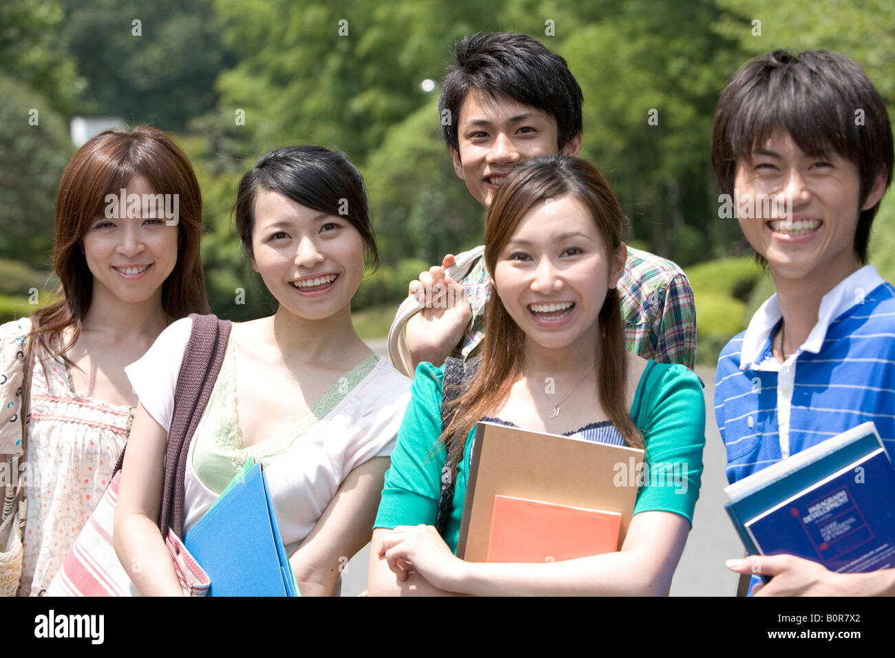Portrait of five teenagers standing in park Stock Photo - Alamy