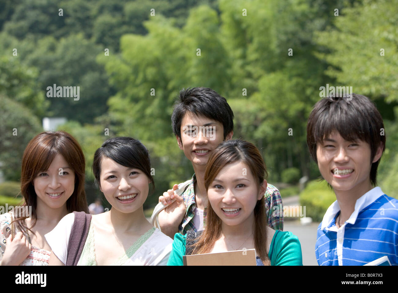 Portrait of five teenagers standing in park Stock Photo - Alamy