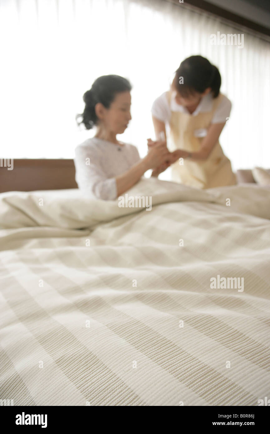 Leaning over bed hi-res stock photography and images - Alamy