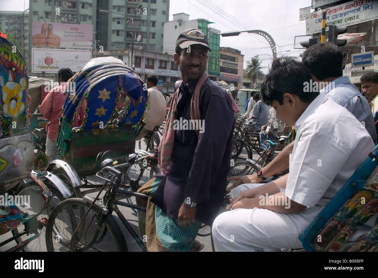 A rickshaw puller in traffic in Bangladesh Stock Photo - Alamy
