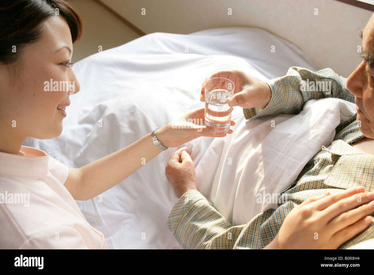Nurse patient in bed drink hi-res stock photography and images - Alamy