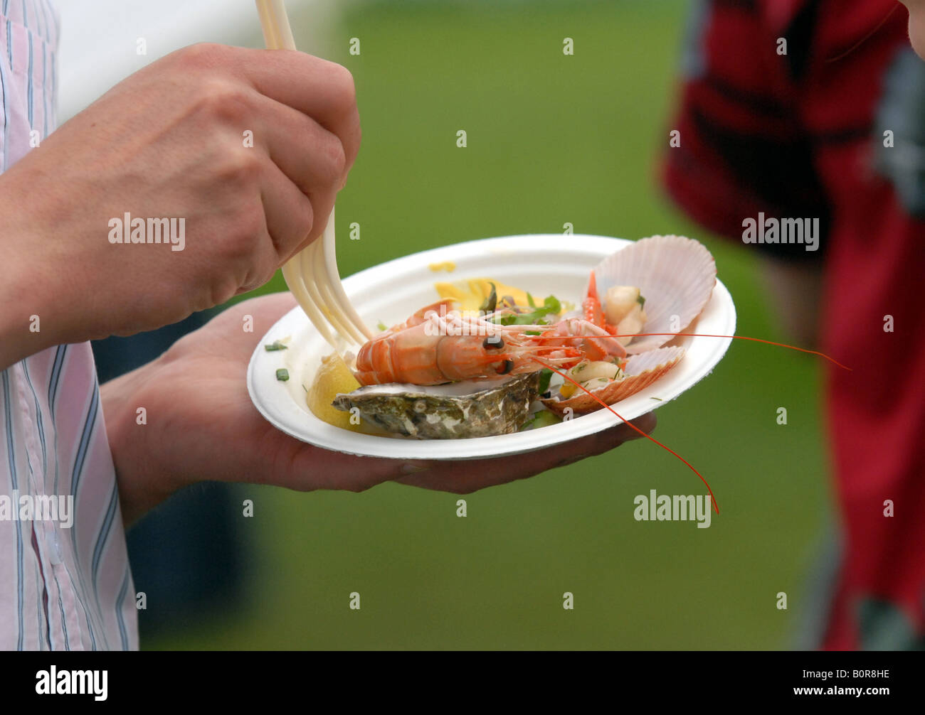 A man eating seafood at a trade fair Stock Photo - Alamy