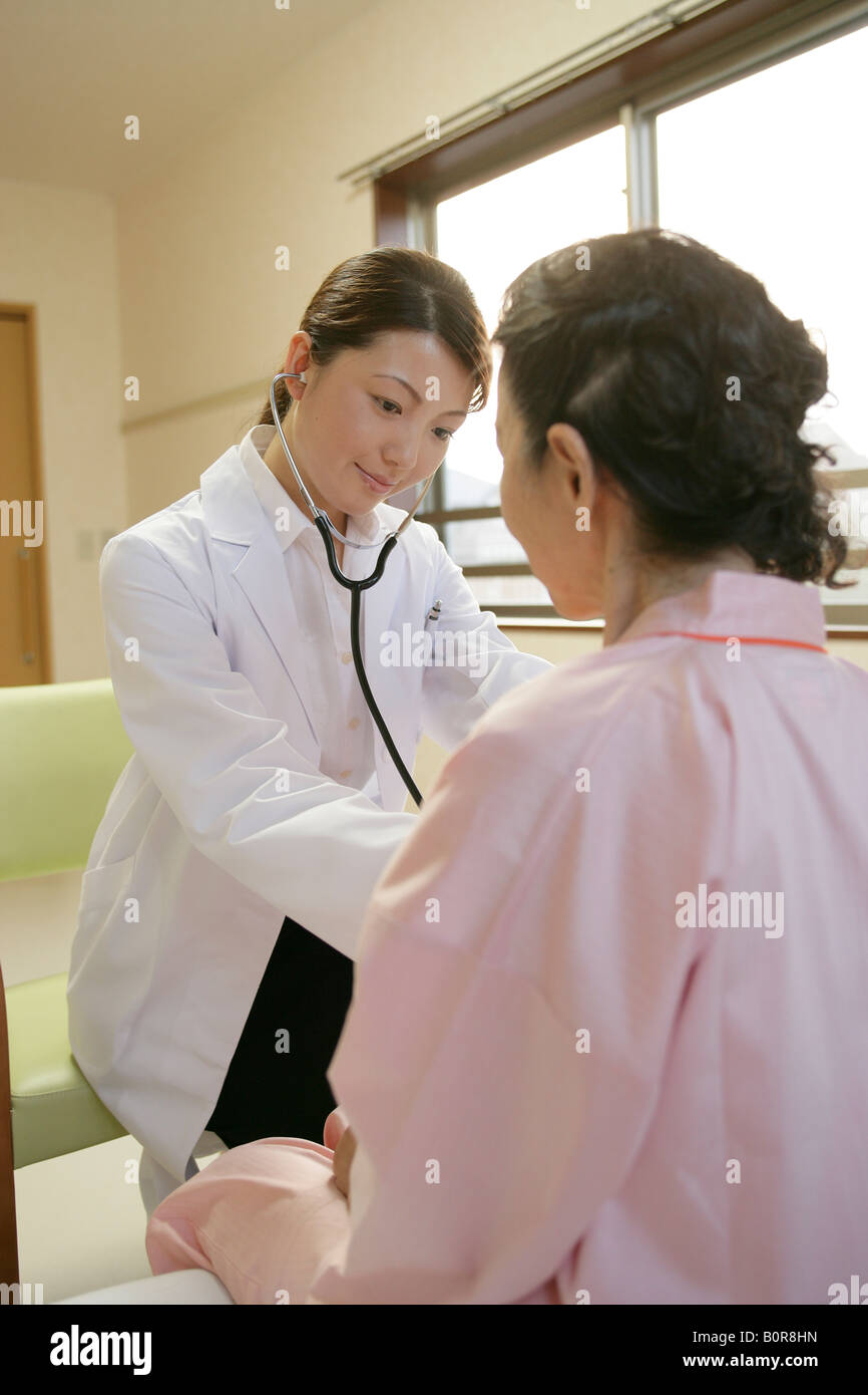 Female doctor examining senior woman Stock Photo - Alamy