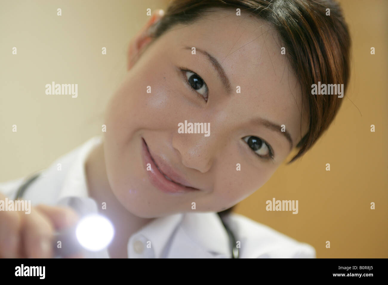 Female doctor holding flashlight, portrait Stock Photo - Alamy