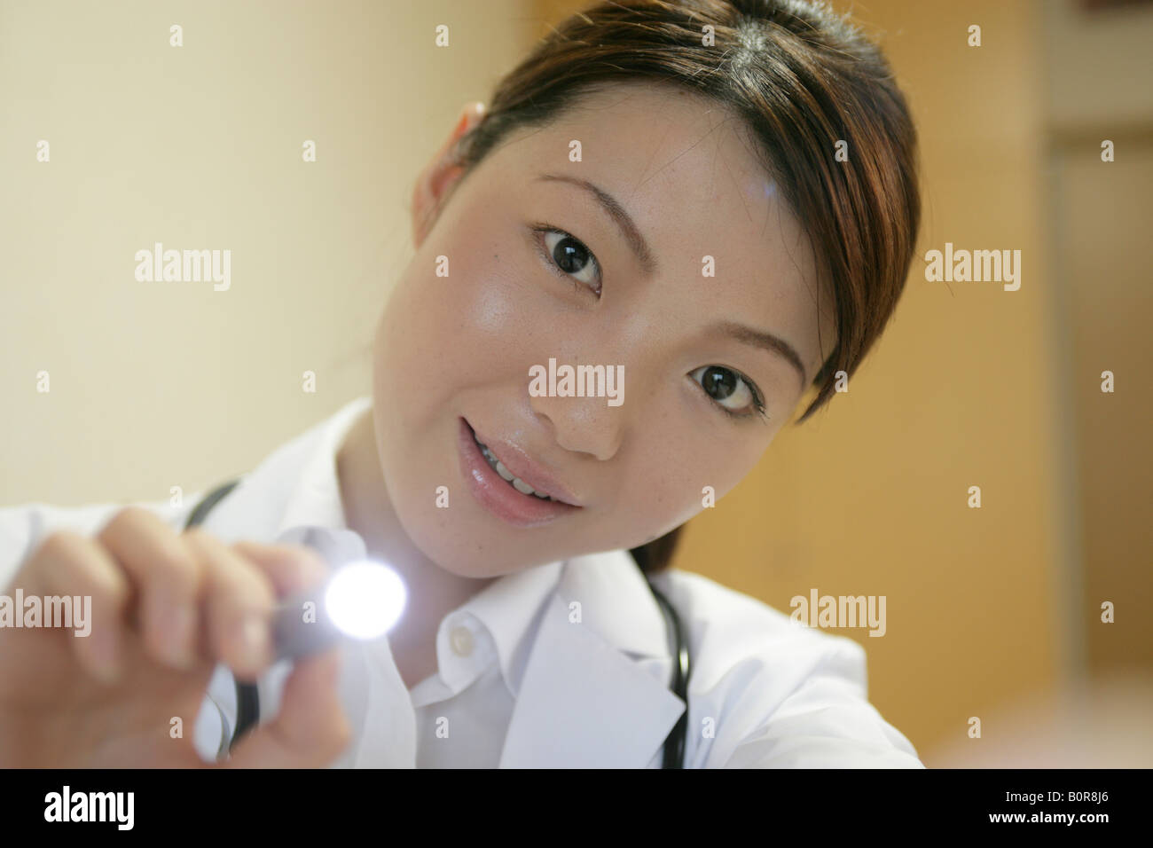 Female doctor holding flashlight, portrait Stock Photo - Alamy