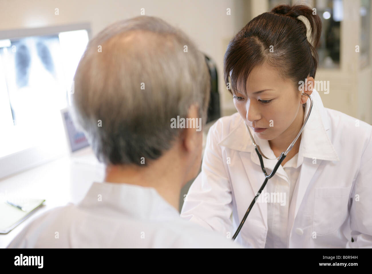 Doctor examining patient Stock Photo - Alamy
