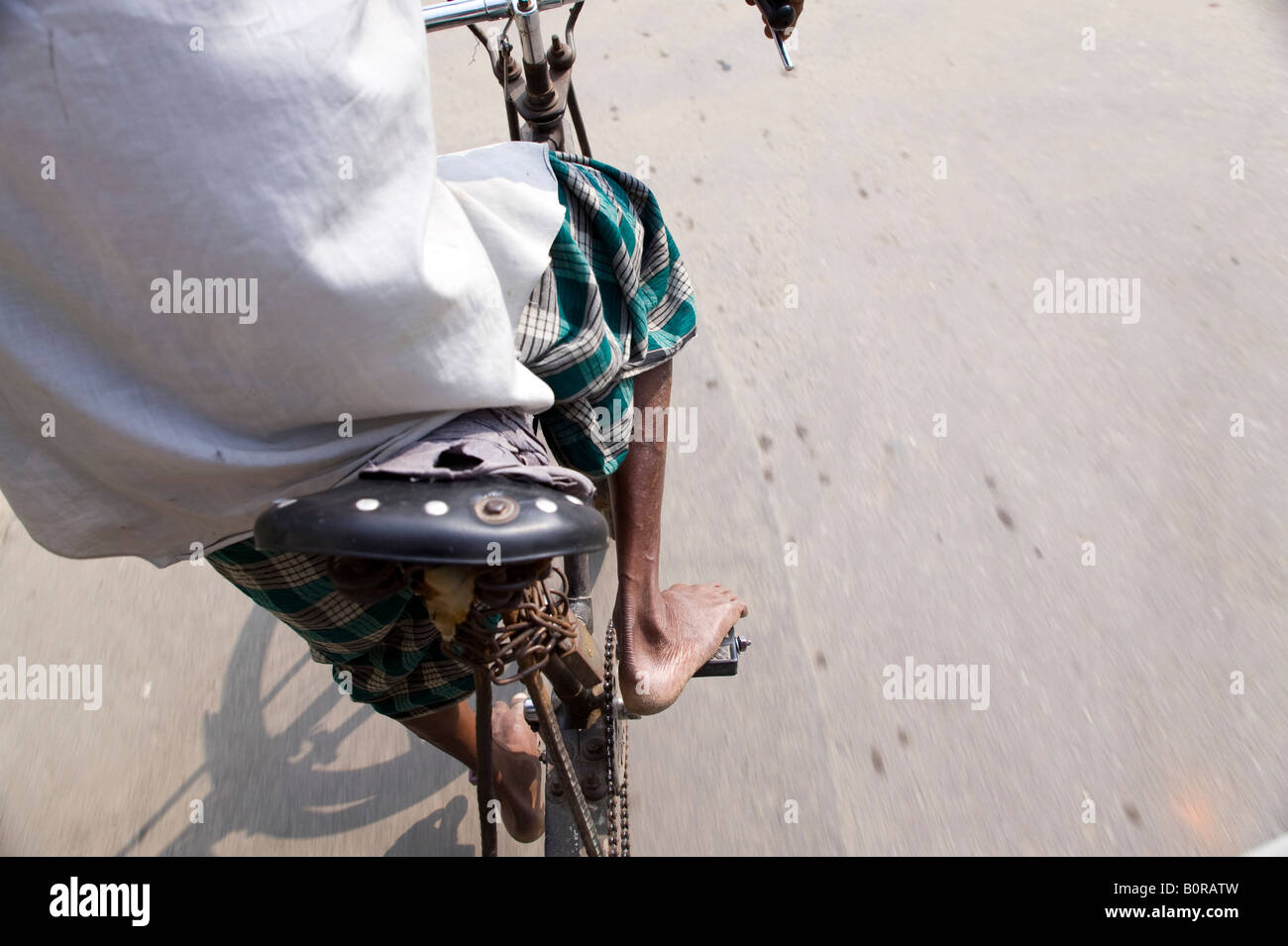 Rickshaw puller pedaling rickshaw in Bangladesh Stock Photo - Alamy