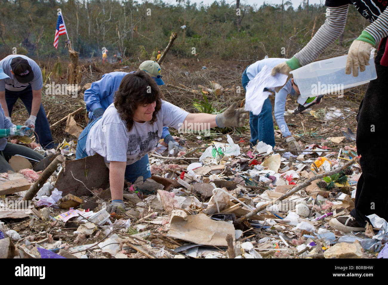 Disaster relief workers pick through destruction to find personal ...