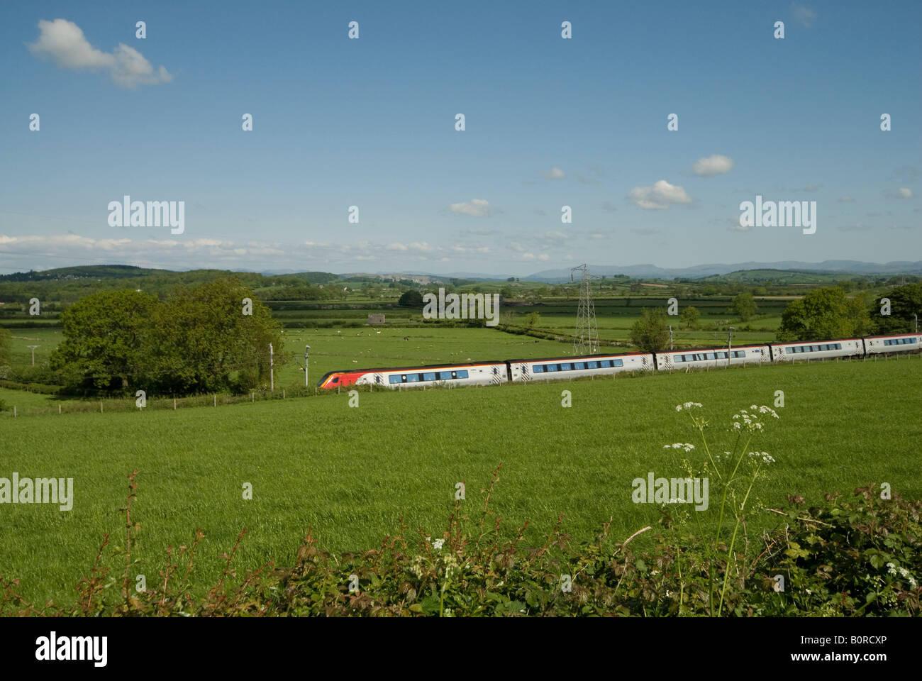 train moving through rural landscape Stock Photo - Alamy