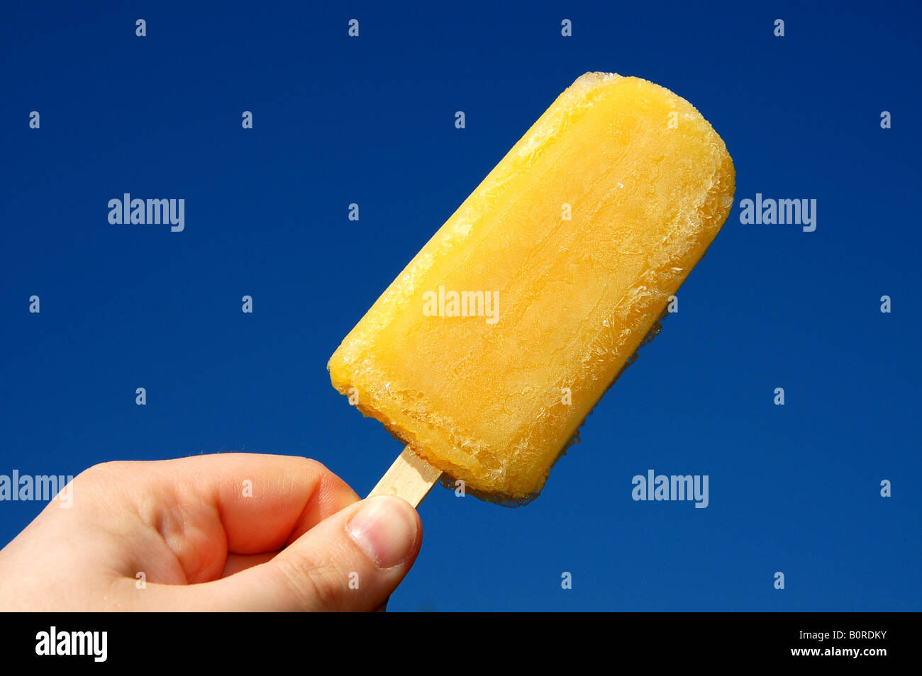 Ice lolly against a vivid blue sky Stock Photo - Alamy