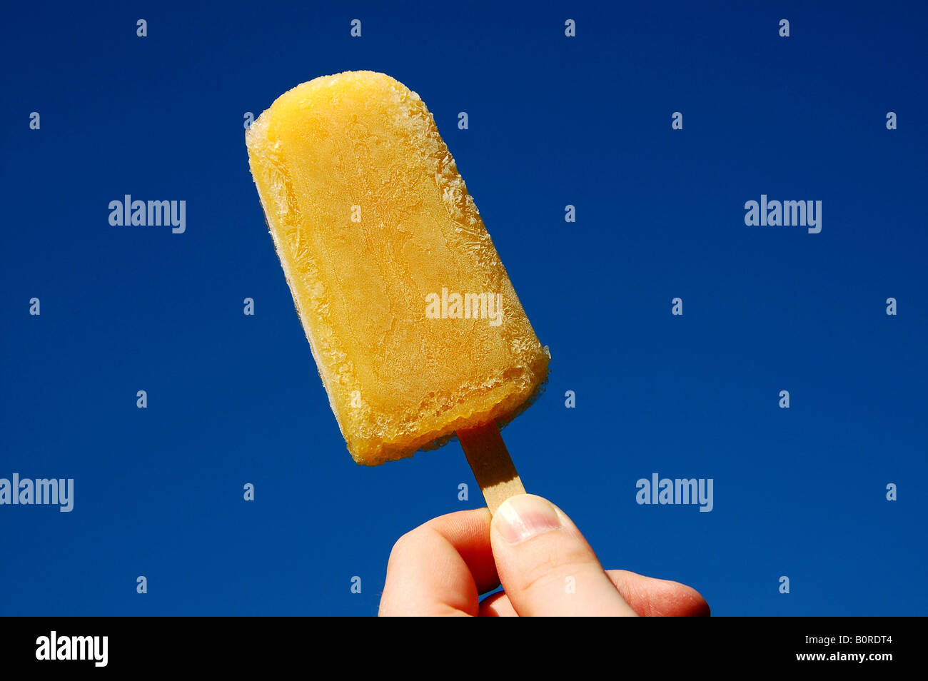 Ice lolly against a vivid blue sky Stock Photo - Alamy