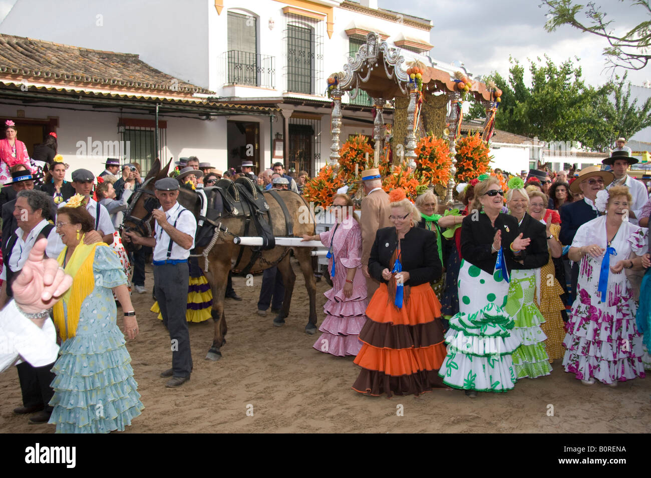 people walking through El Rocío during the romeria Stock Photo - Alamy