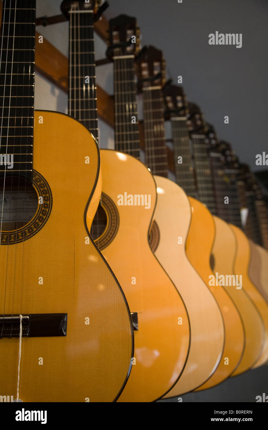 Line of guitars for sale on a musical instruments store, Seville, Spain ...