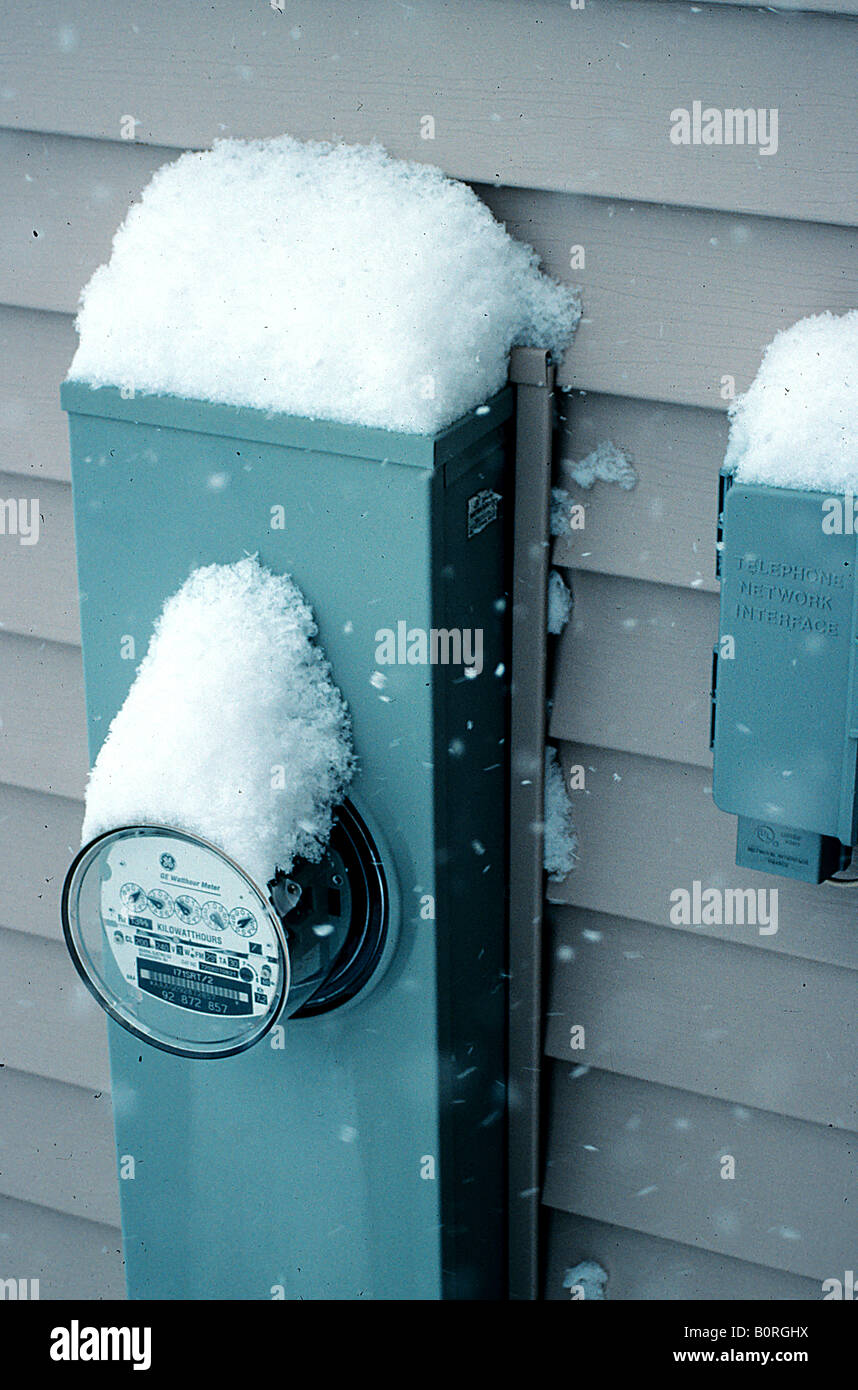 Electrical meter covered with snow energy efficiency savings flakes ...