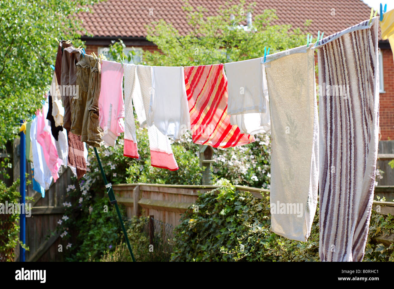 Washing drying on a line in a garden Stock Photo - Alamy