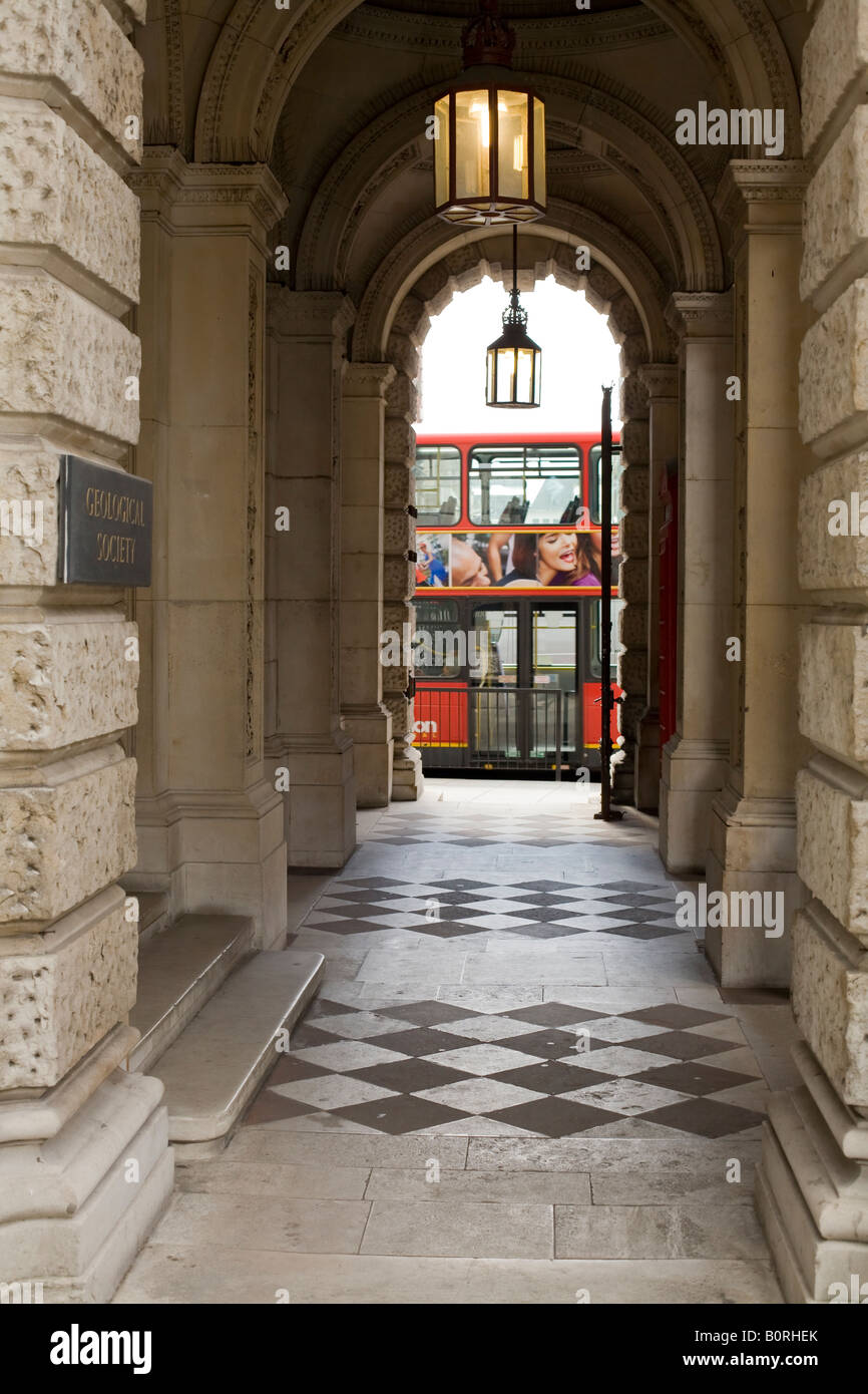Archway off Royal Academy courtyard with London bus behind Stock Photo ...