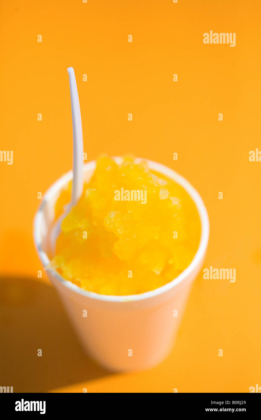 mango snowball with spoon on orange background Stock Photo - Alamy