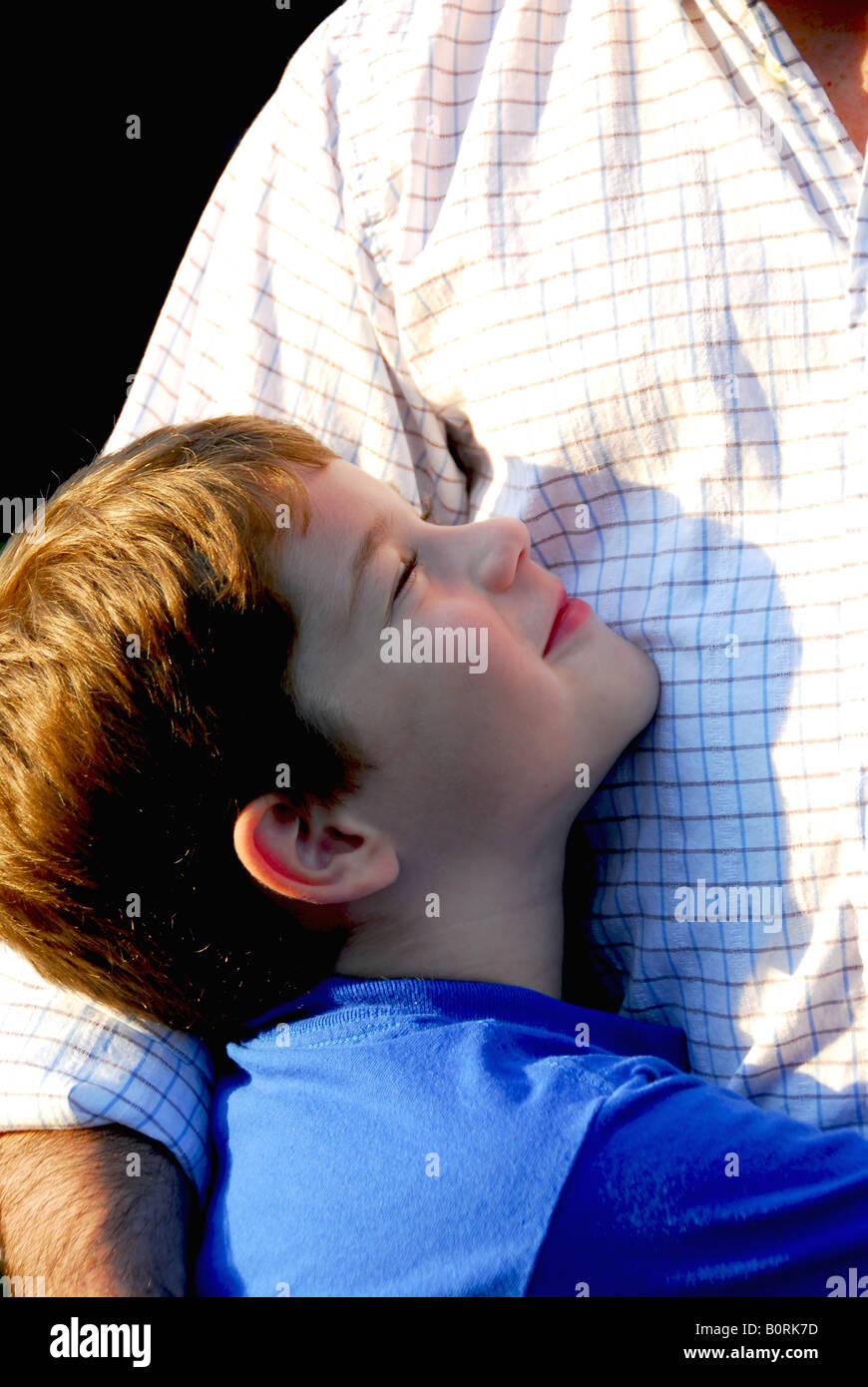 Little boy hugging his father and looking up Stock Photo - Alamy