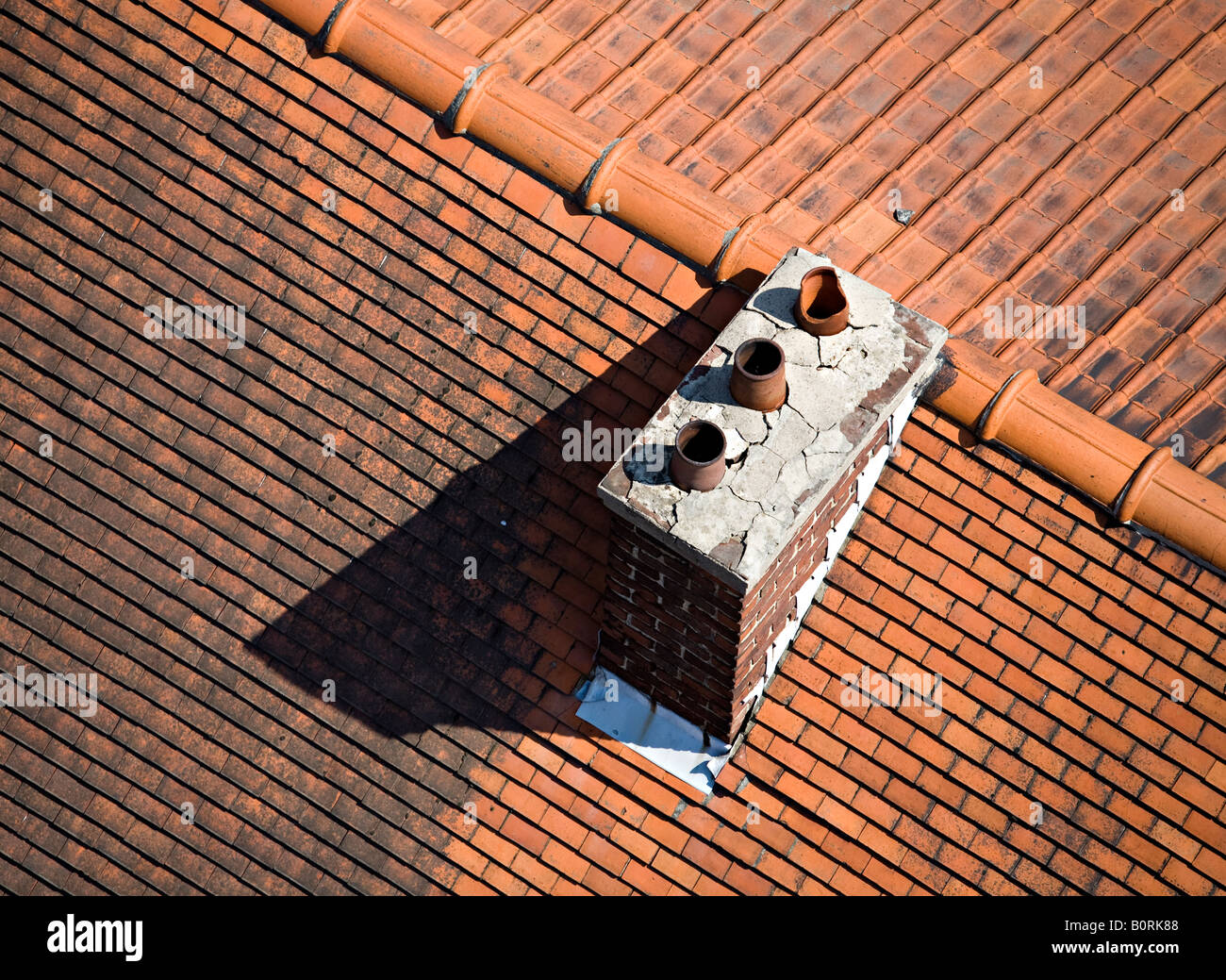 Chimney pots with cracked concrete rendering on tiled roof Belgium ...
