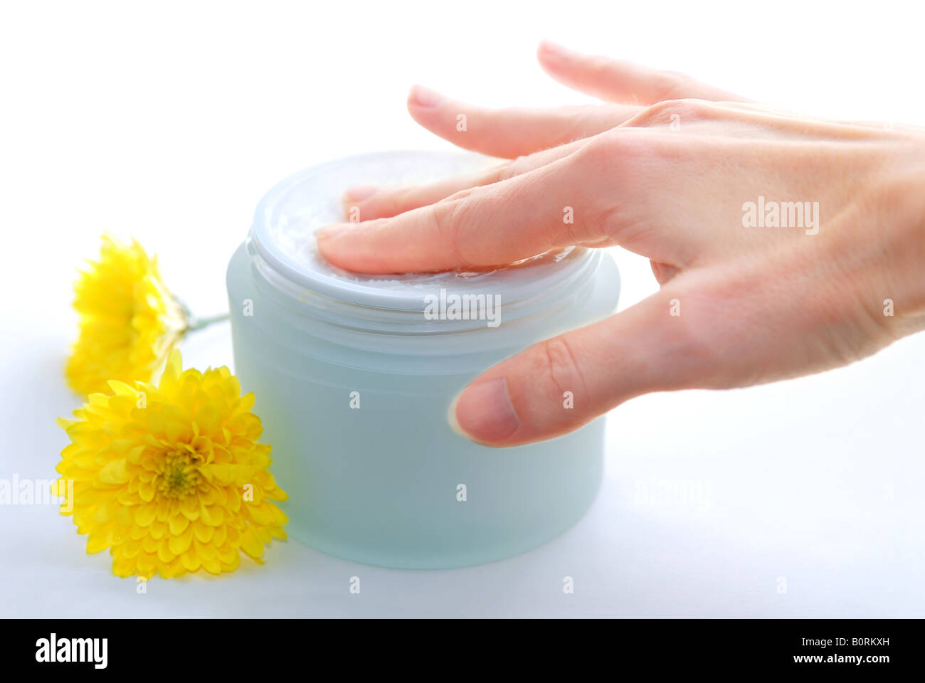 Woman s hand touching a creame in open jar Stock Photo - Alamy