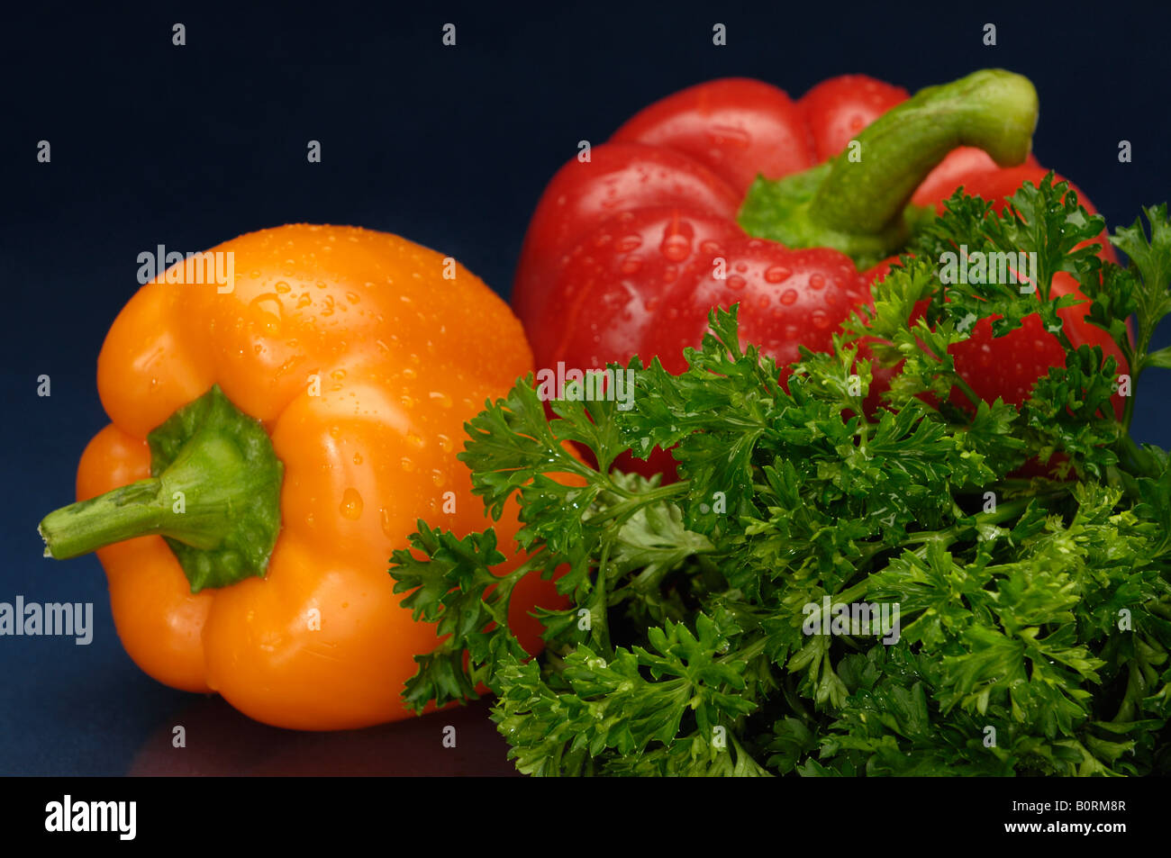 Colorful bell peppers and curly parsley Stock Photo - Alamy