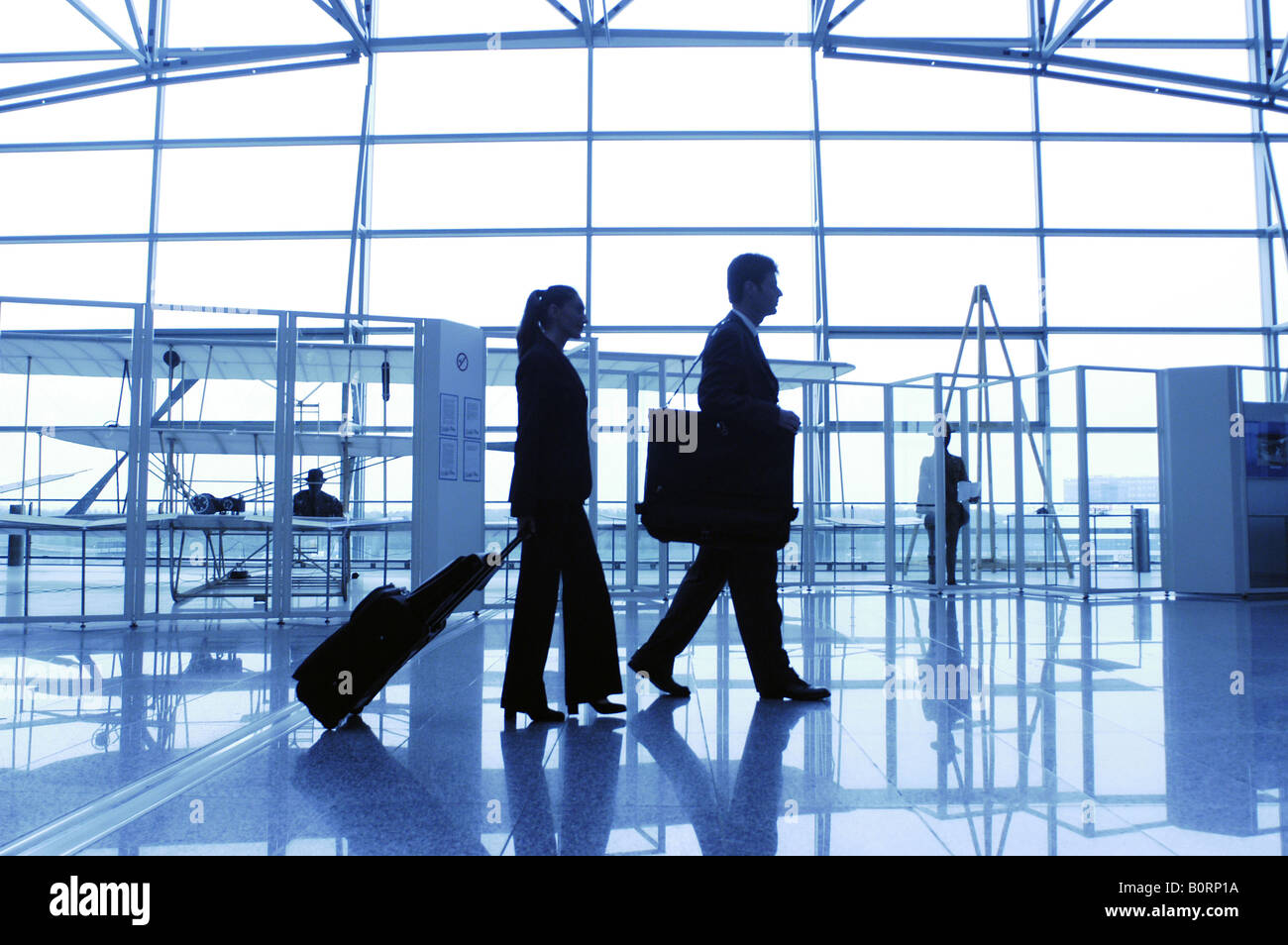 Two businessmen walking trough a terminal building Stock Photo - Alamy