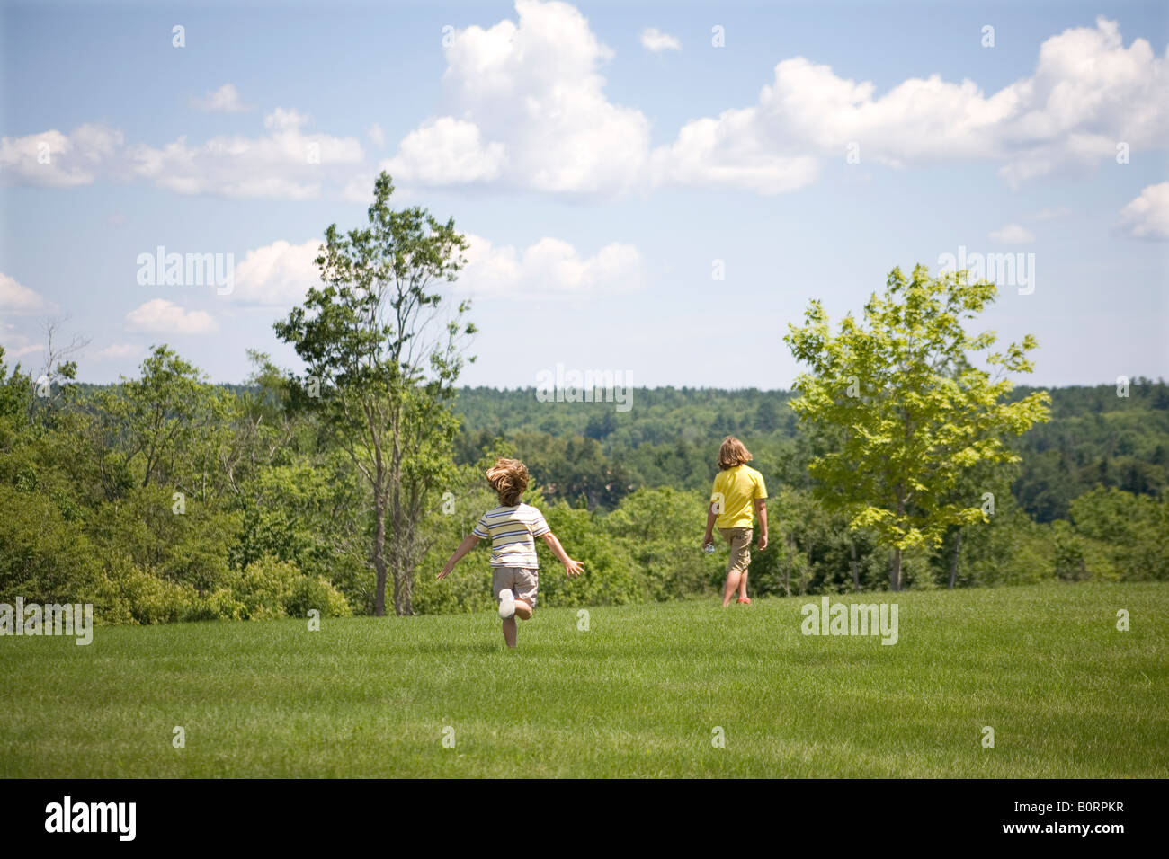 two children play in a large open field on a nice day Stock Photo - Alamy