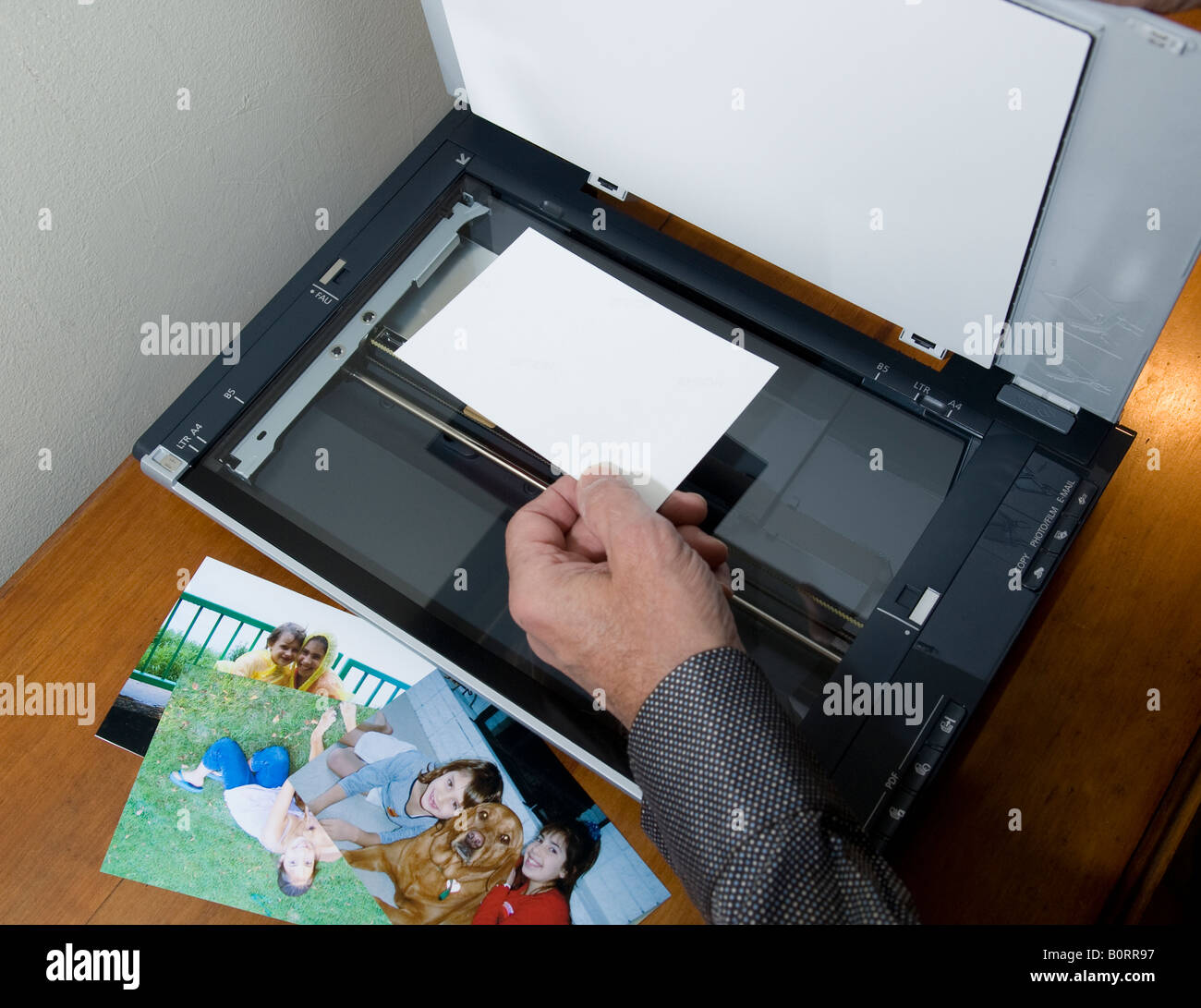 man scanning photos of children with flatbed scanner Stock Photo - Alamy