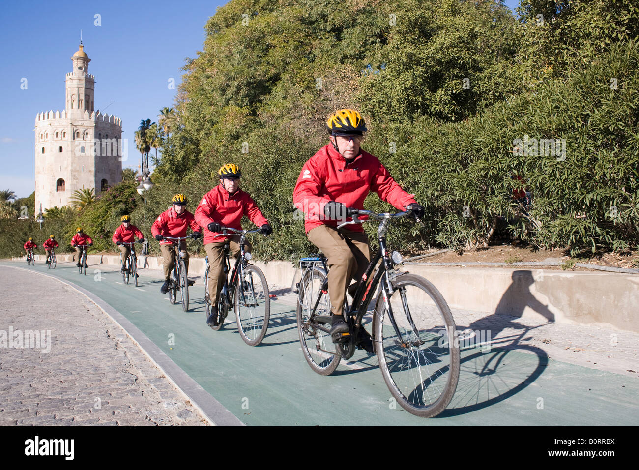 Digital sequence of a man riding a bike by the Golden Tower, Seville ...