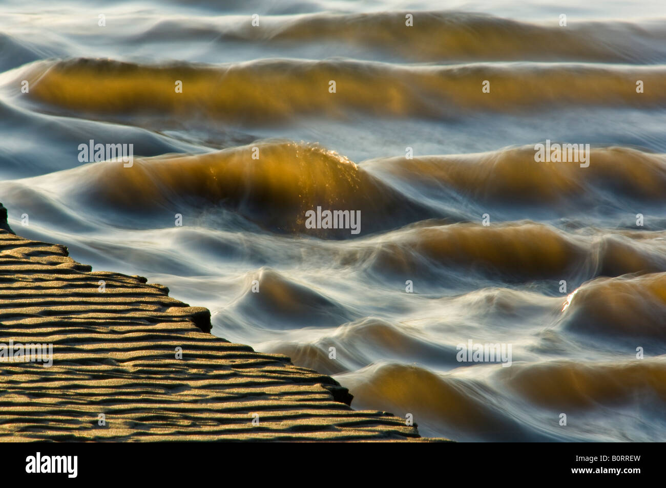 Erosion detail ripples in sand and water at Morro Strand State Beach ...