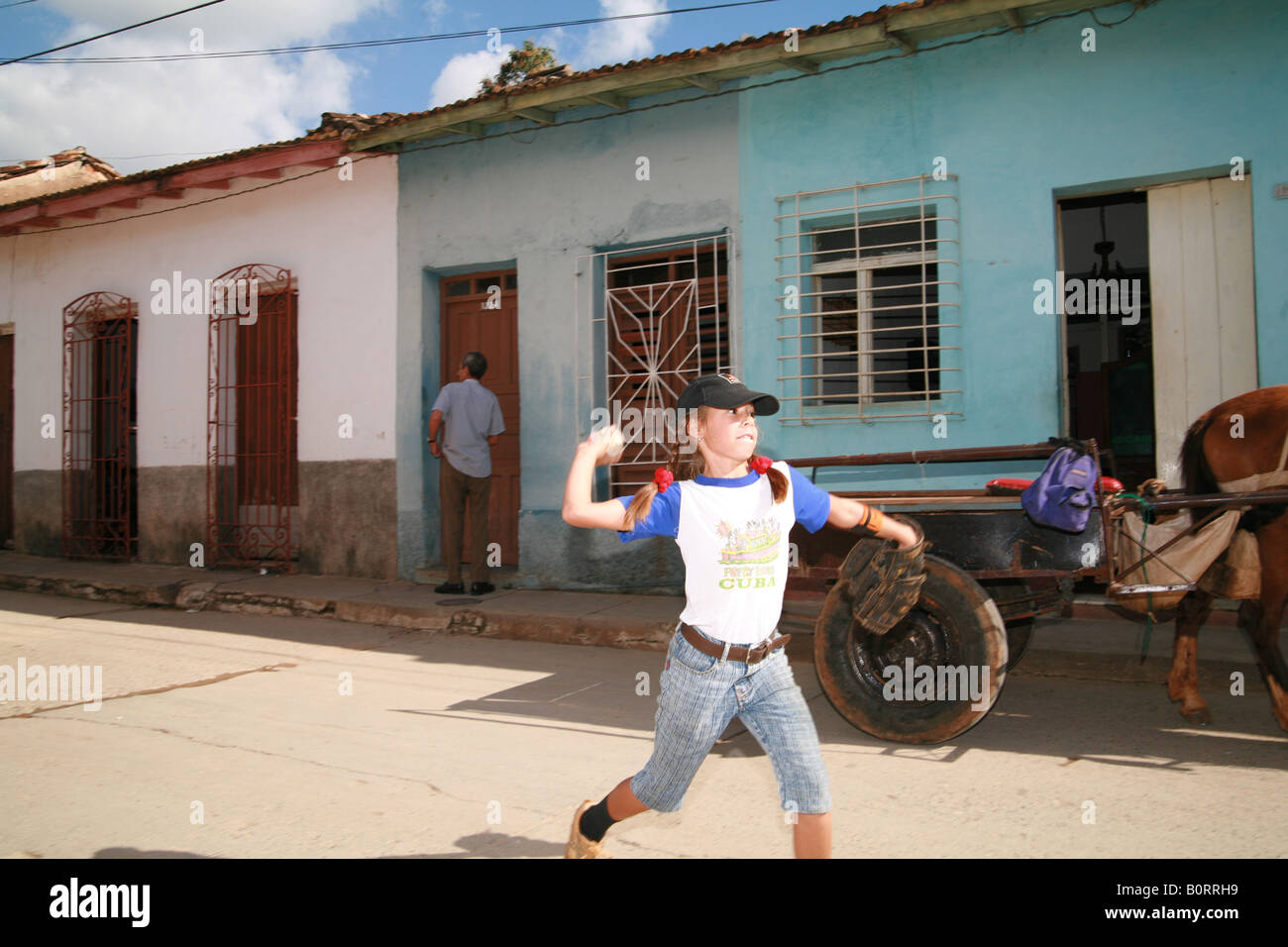 Boy playing baseball on a street in Trinidad, Sancti-Spíritus Province ...