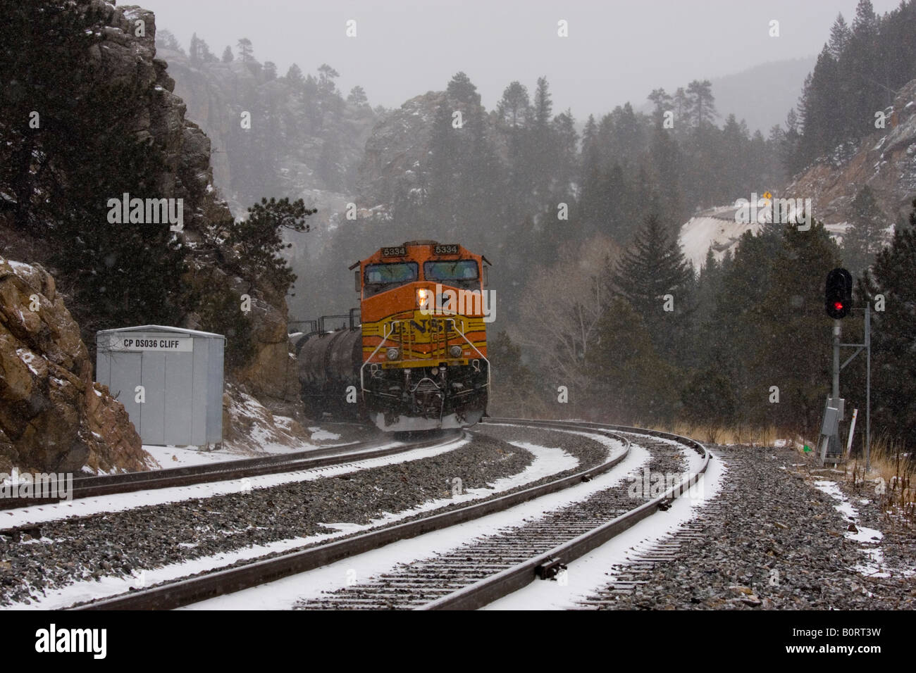 BNSF freight train steams through the Rocky Mountains during a cold ...